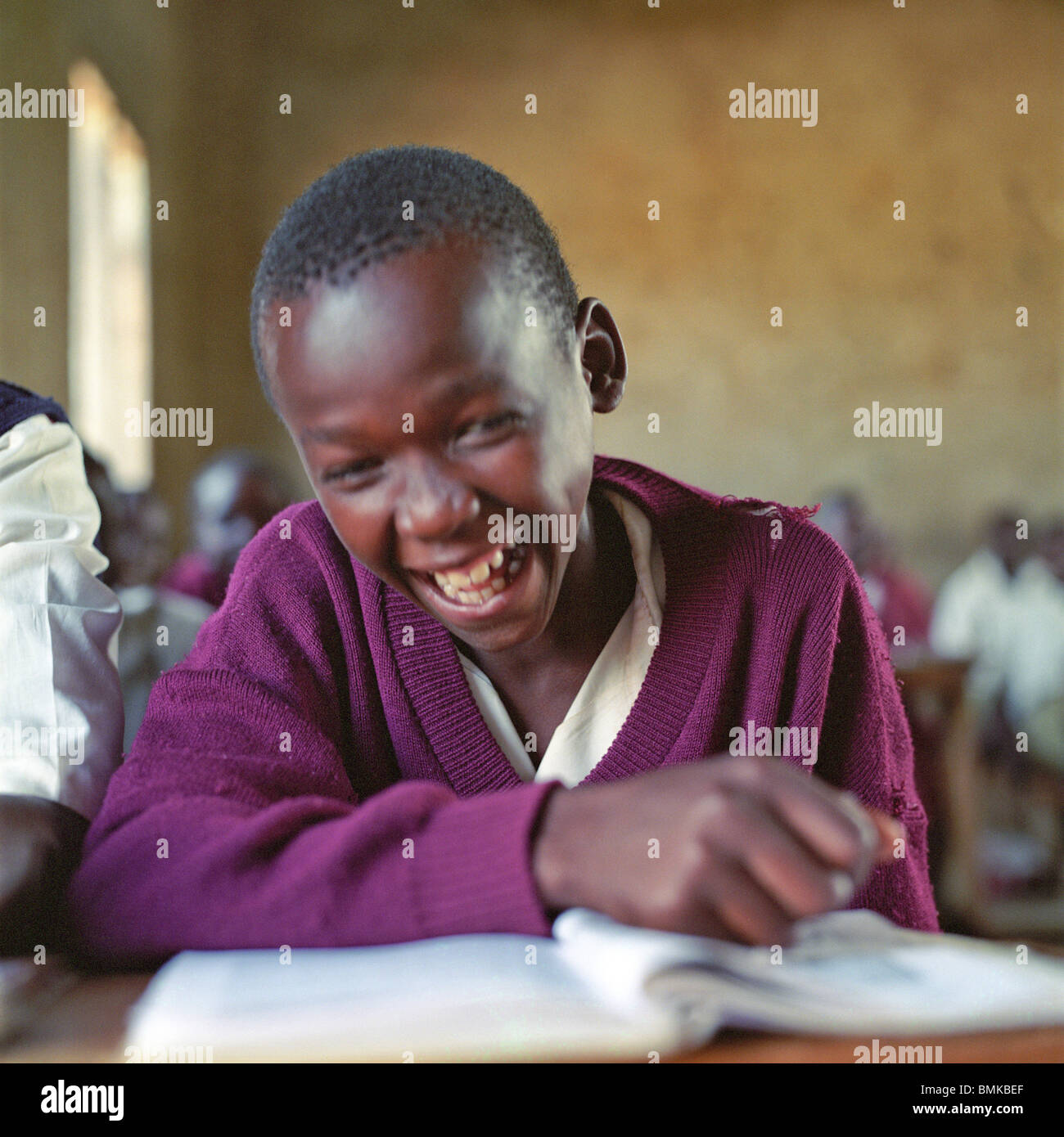 Young Kenyan boys wearing ragged school uniform in traditional village ...