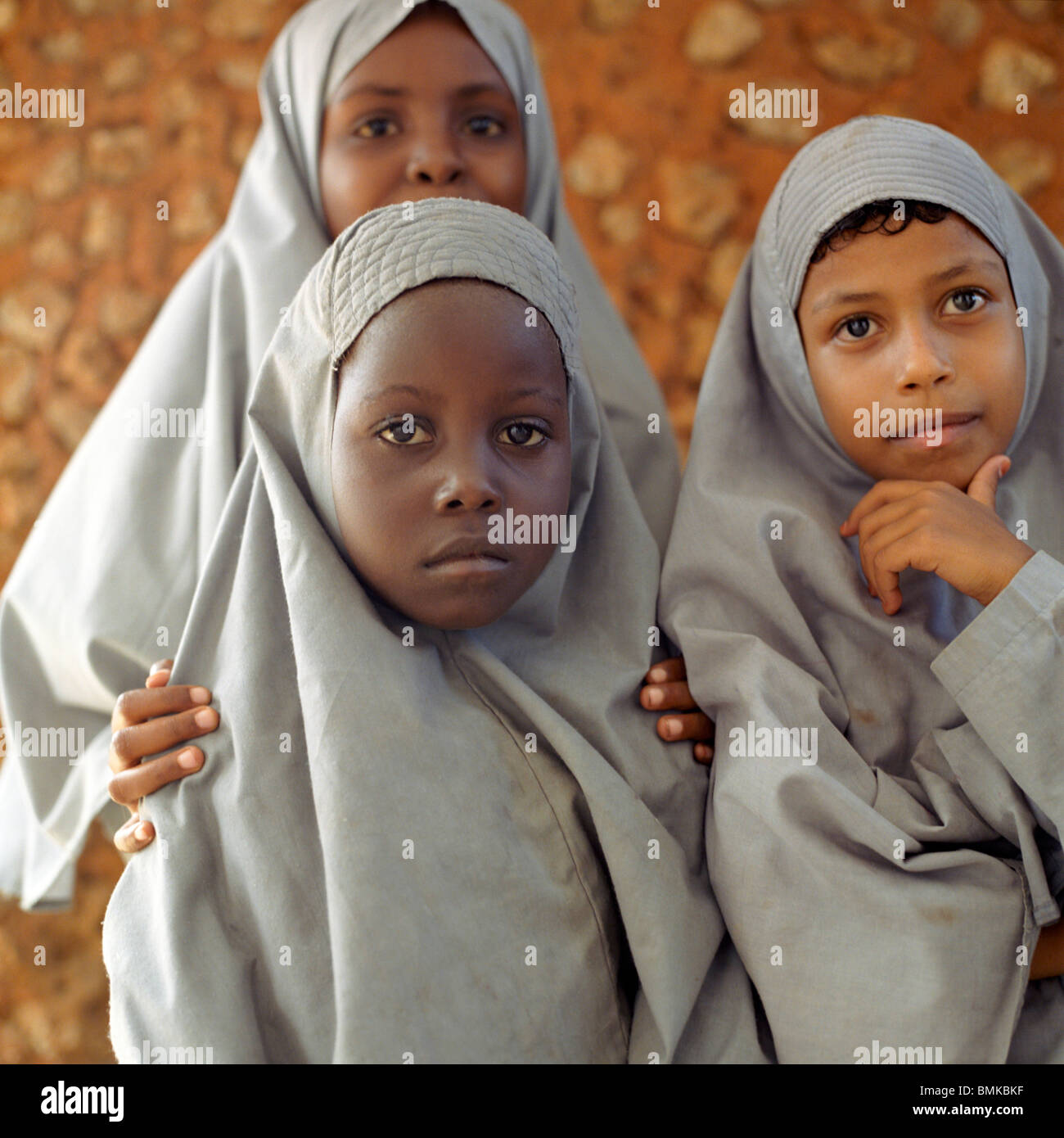 Young african muslim girls in Kenya in front of a mud hut in a ...