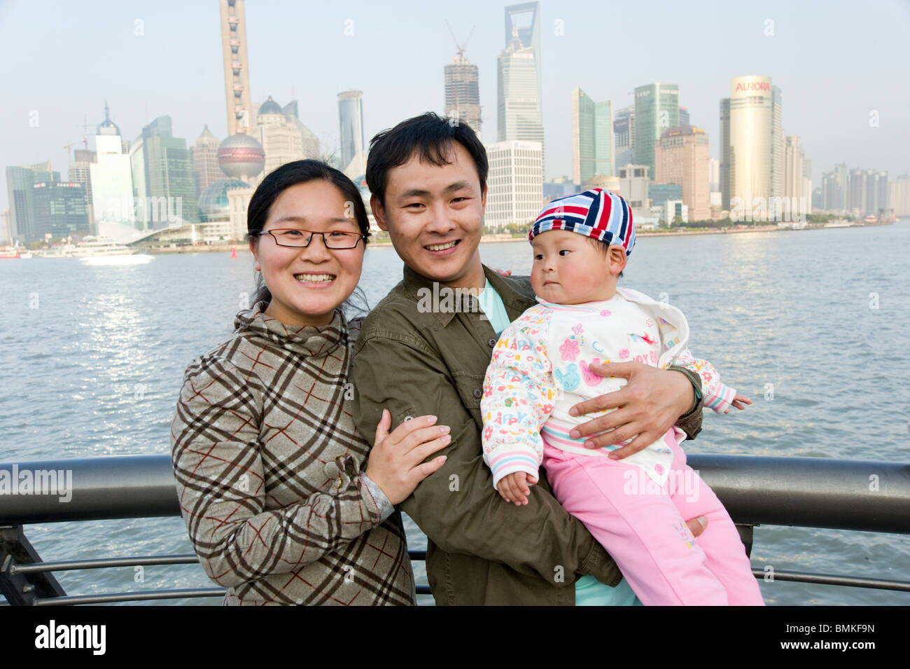 Young family with single child on the waterfront, Shanghai, China Stock ...