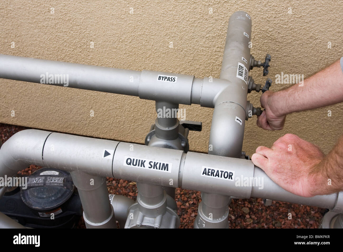 Man turning valve of a swimming pool system Stock Photo - Alamy