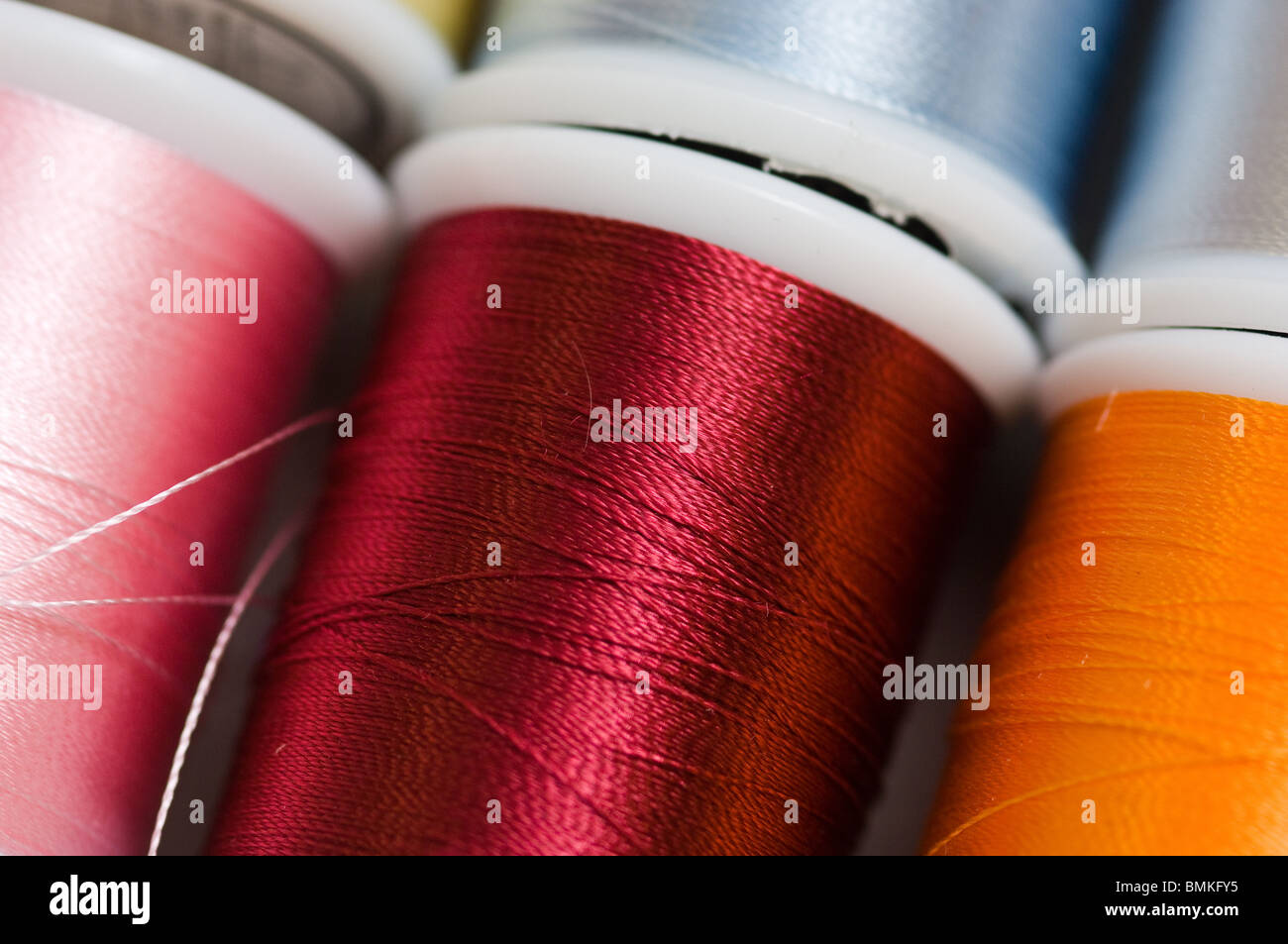 Rolls of brightly coloured cotton thread Stock Photo - Alamy