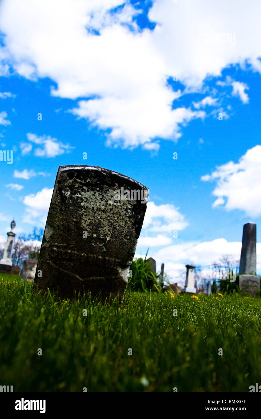 A dark tombstone on a beautiful spring day Stock Photo - Alamy
