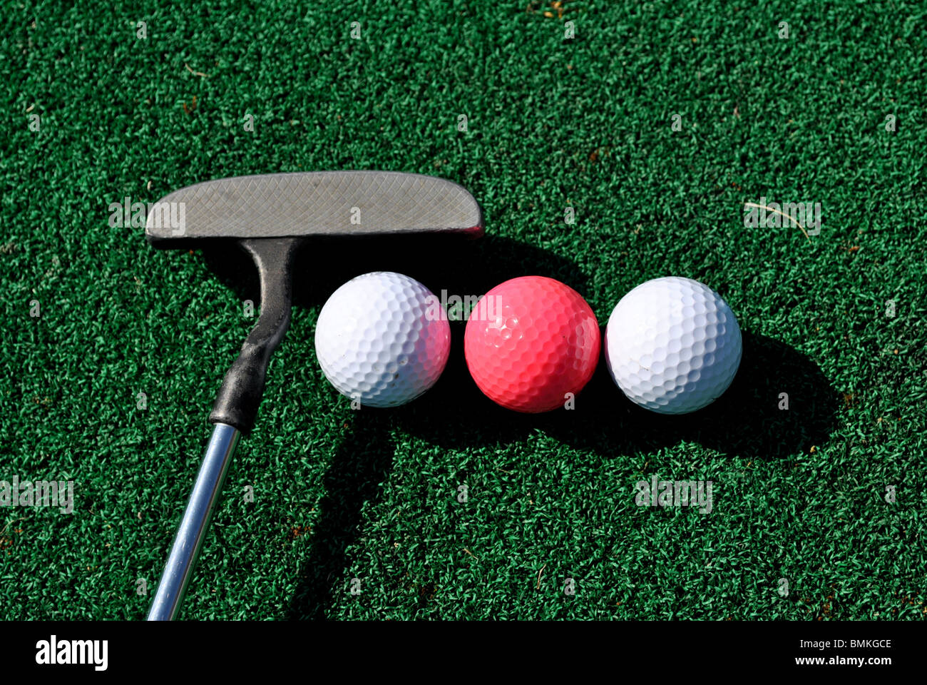putter and three balls Stock Photo - Alamy