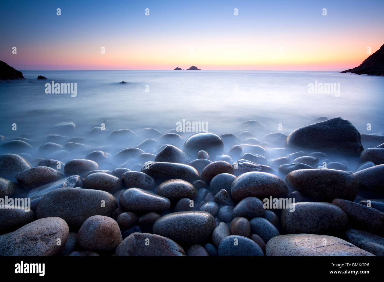 Boulders on beach at sunset Cornwall Stock Photo - Alamy
