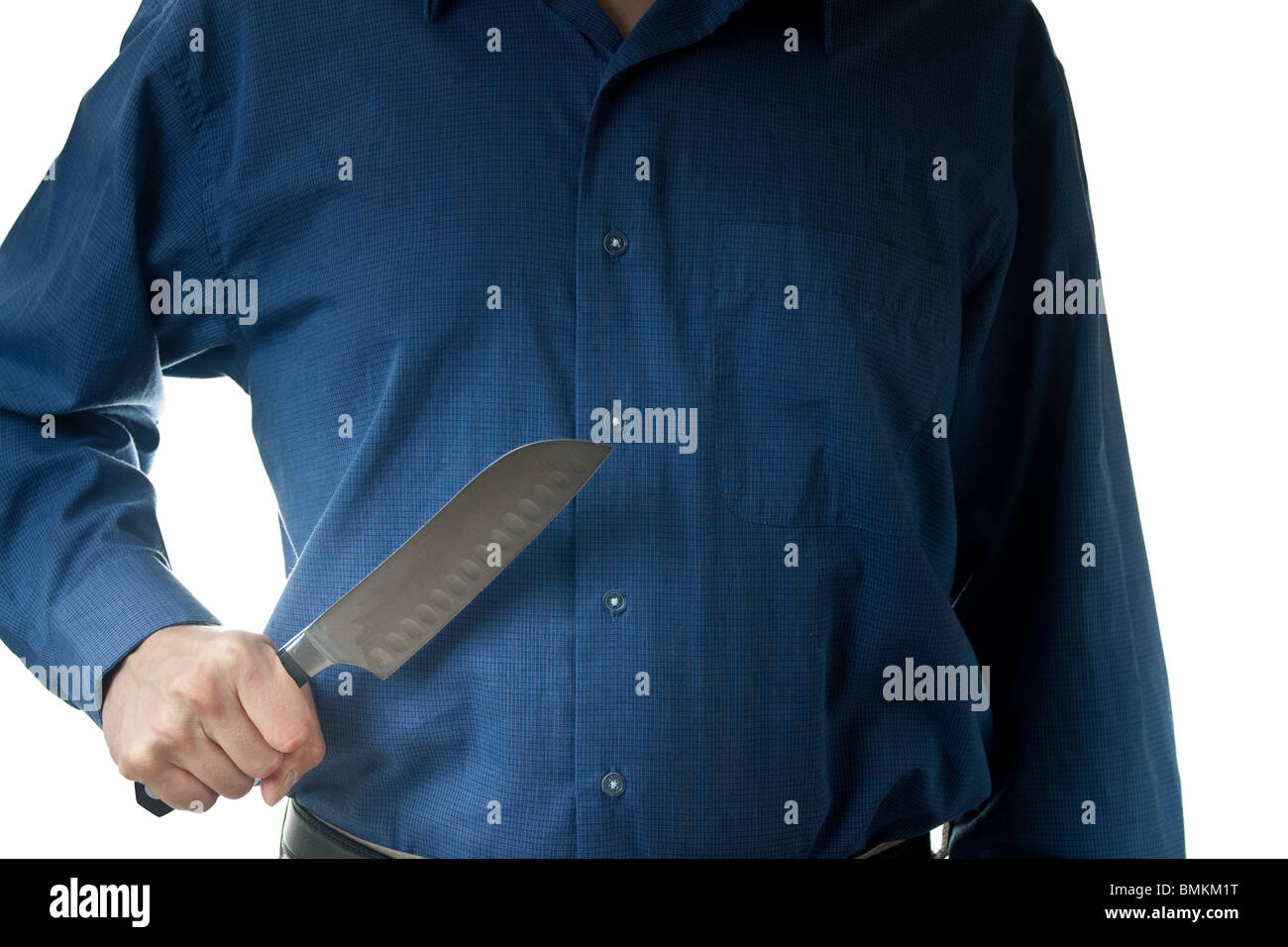 The mid-section of a man in a blue dress shirt, holding a large knife ...