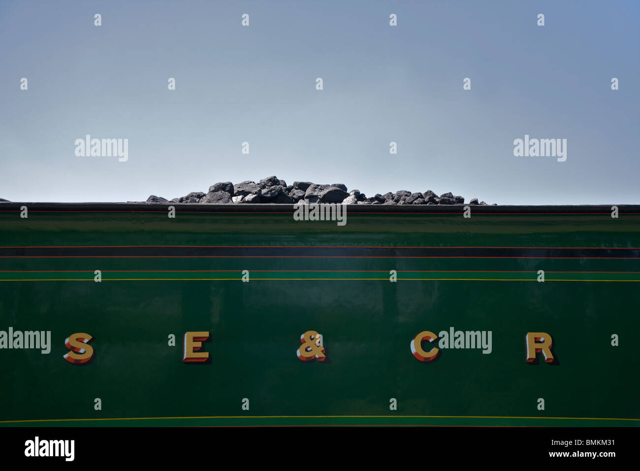 Coal tender of a railway steam locomotive SE & CR set against a blue ...