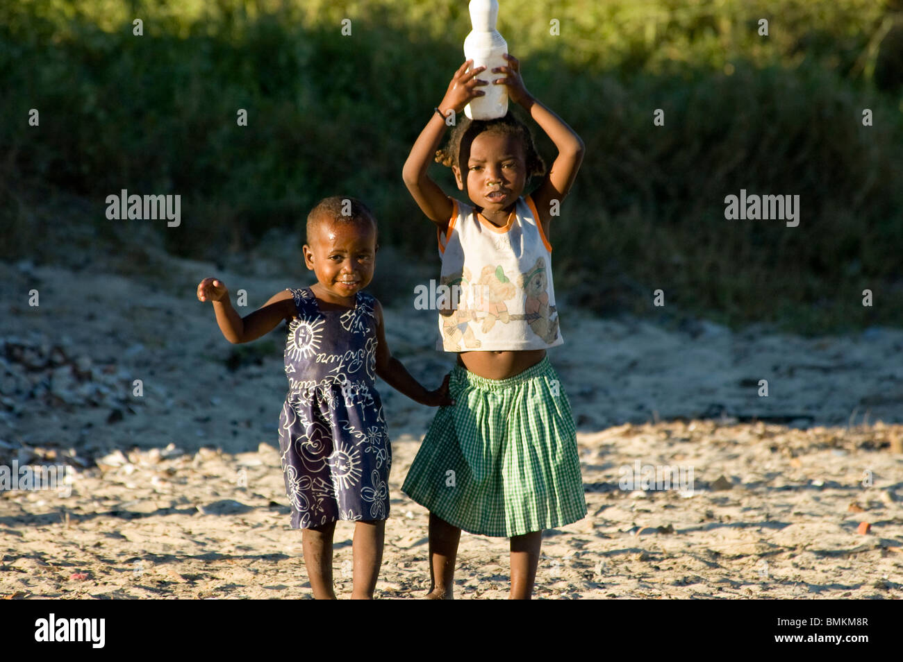 Madagascar, Mangily. Girls carrying water on their heads Stock Photo ...