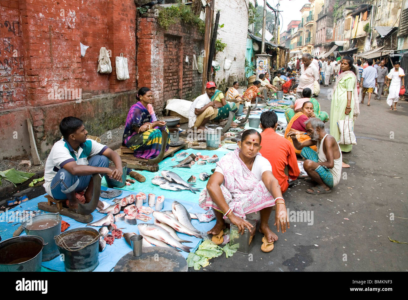 Women and men selling fish in fish market ; Siyaldah ; Calcutta now ...