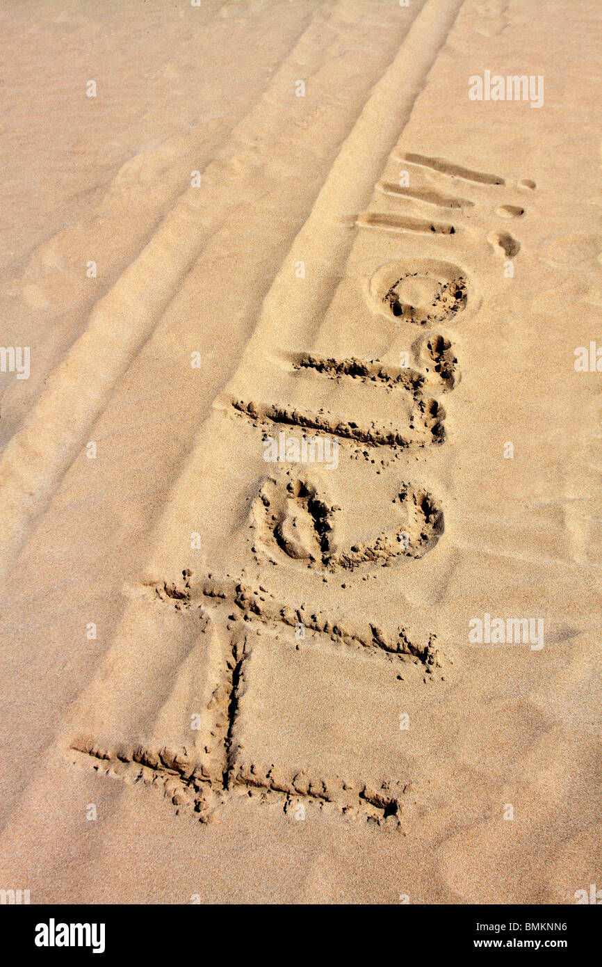 It's the "hello!!!" writing with the sand on the beach Stock Photo - Alamy