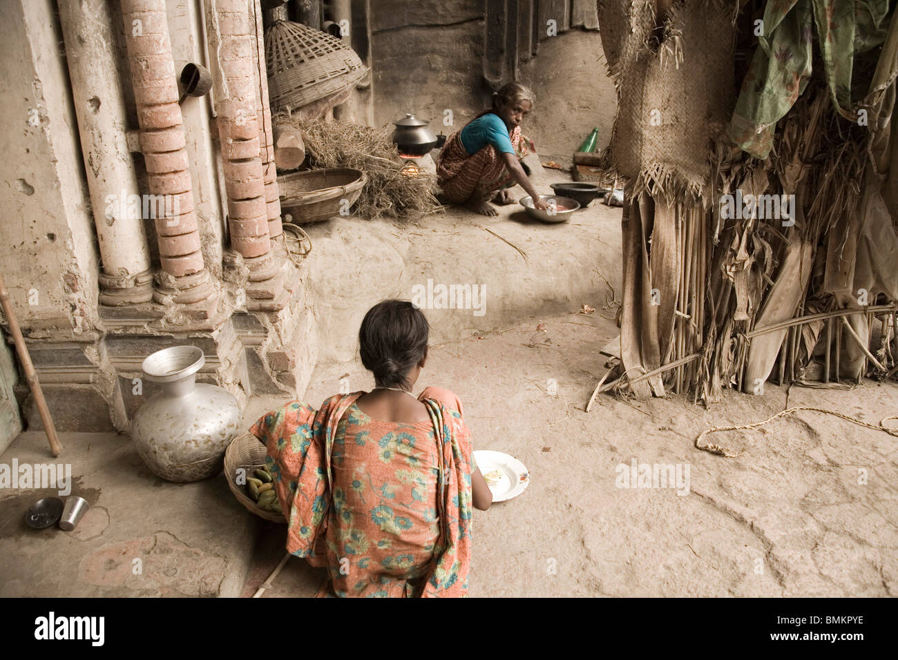Old Lady And Girl Working In Kitchen Village Tauta District