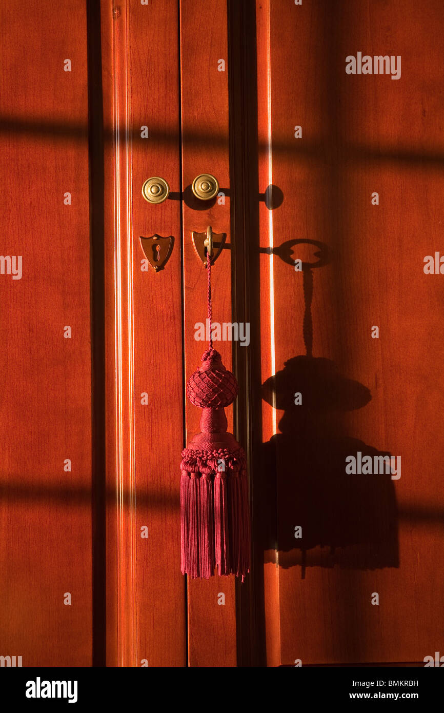Key in closet keyhole casting shadow, close-up Stock Photo - Alamy