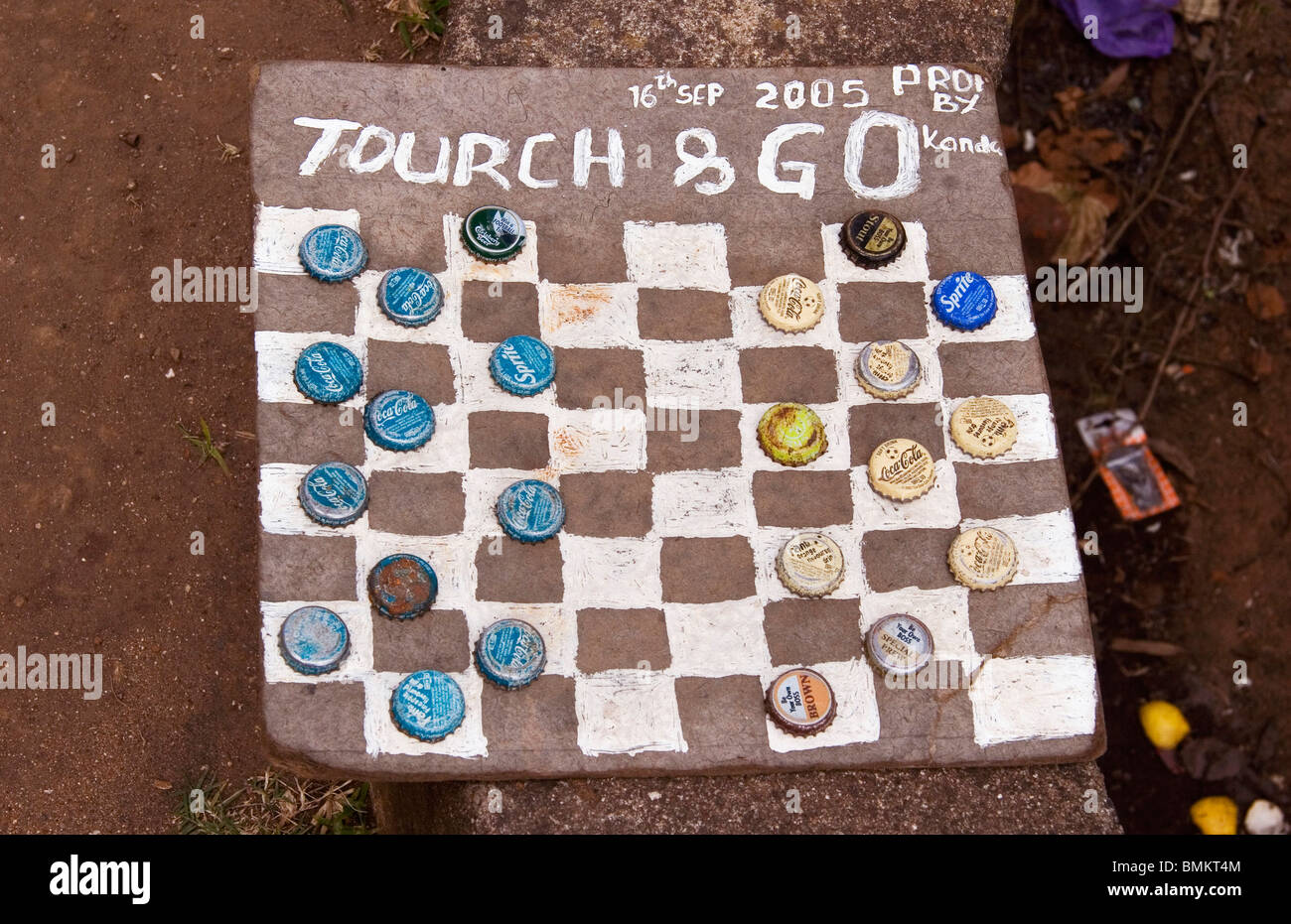 Africa, Malawi, Homemade checkerboard with bottle caps as checkers ...