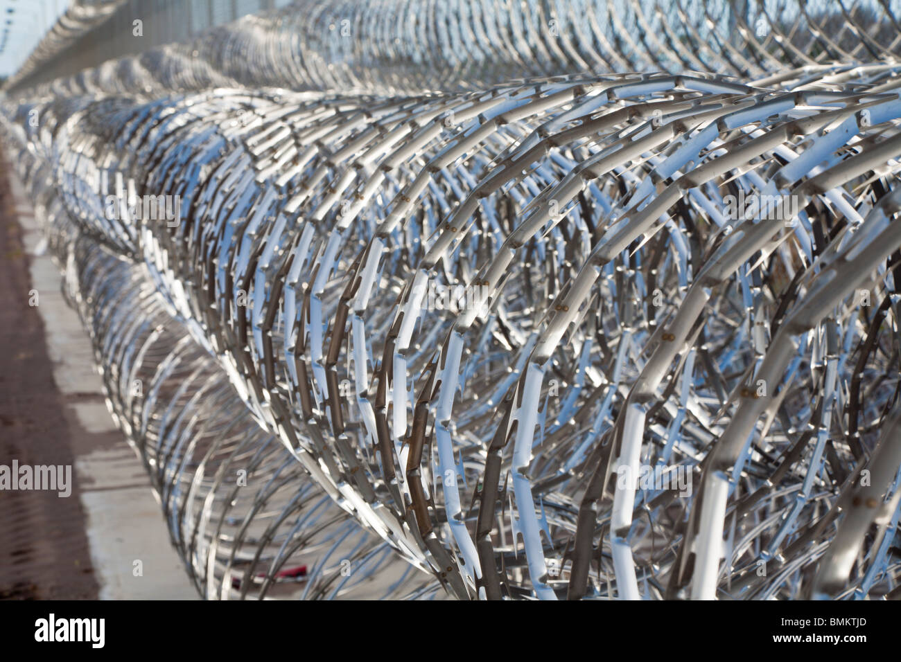 Rolls of stainless steel razor wire spirals keep prisoners away from ...