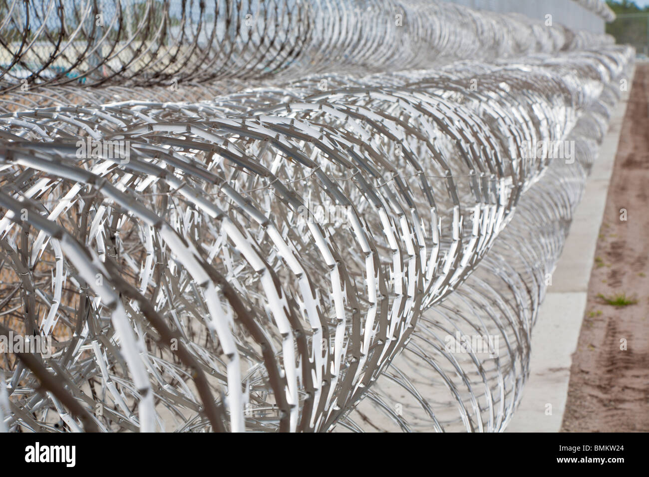 Rolls of stainless steel razor wire spirals keep prisoners away from ...