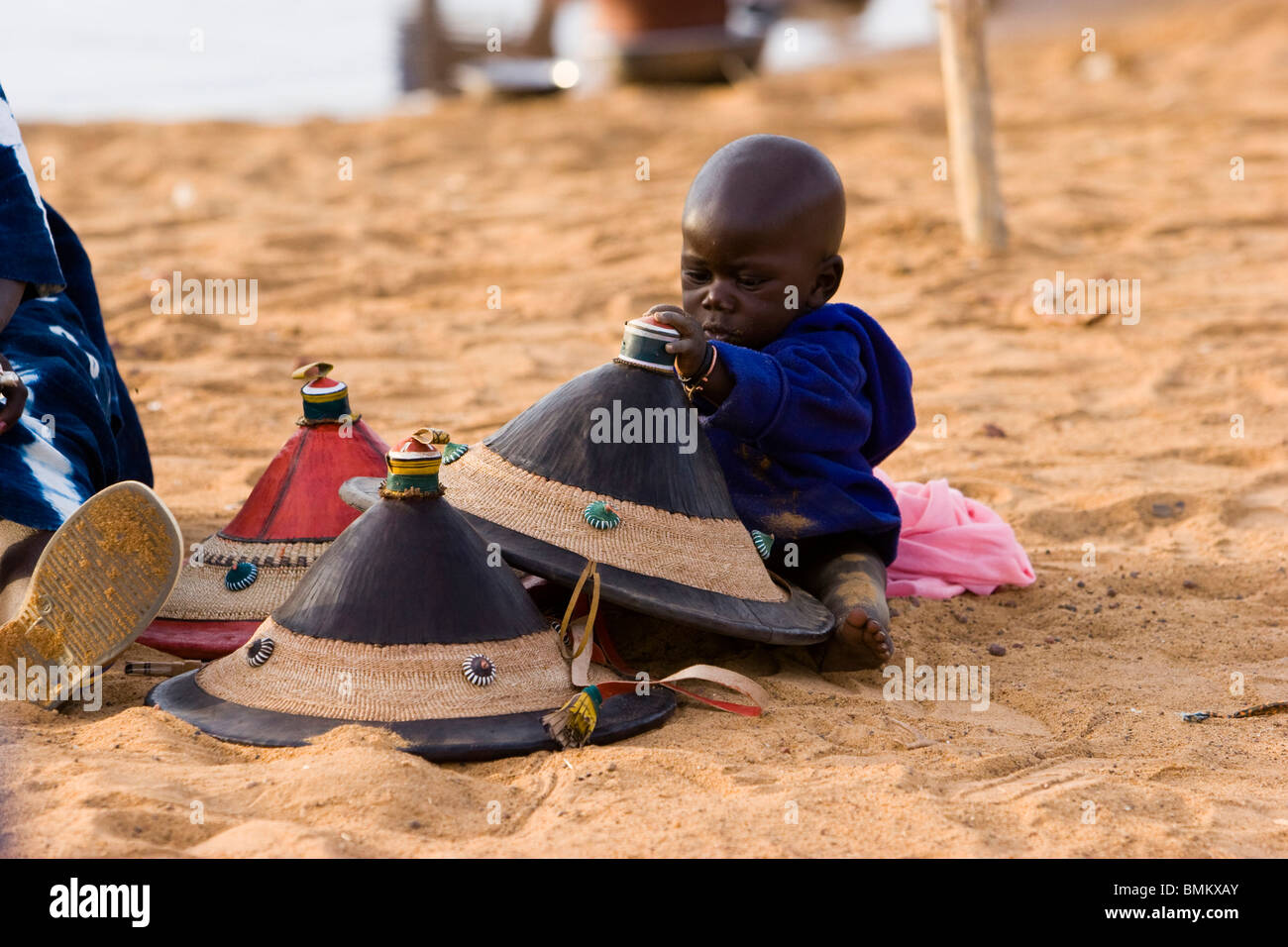 Mali, Djenne. Boy playing with a Fulani hat near the Bani River Stock ...