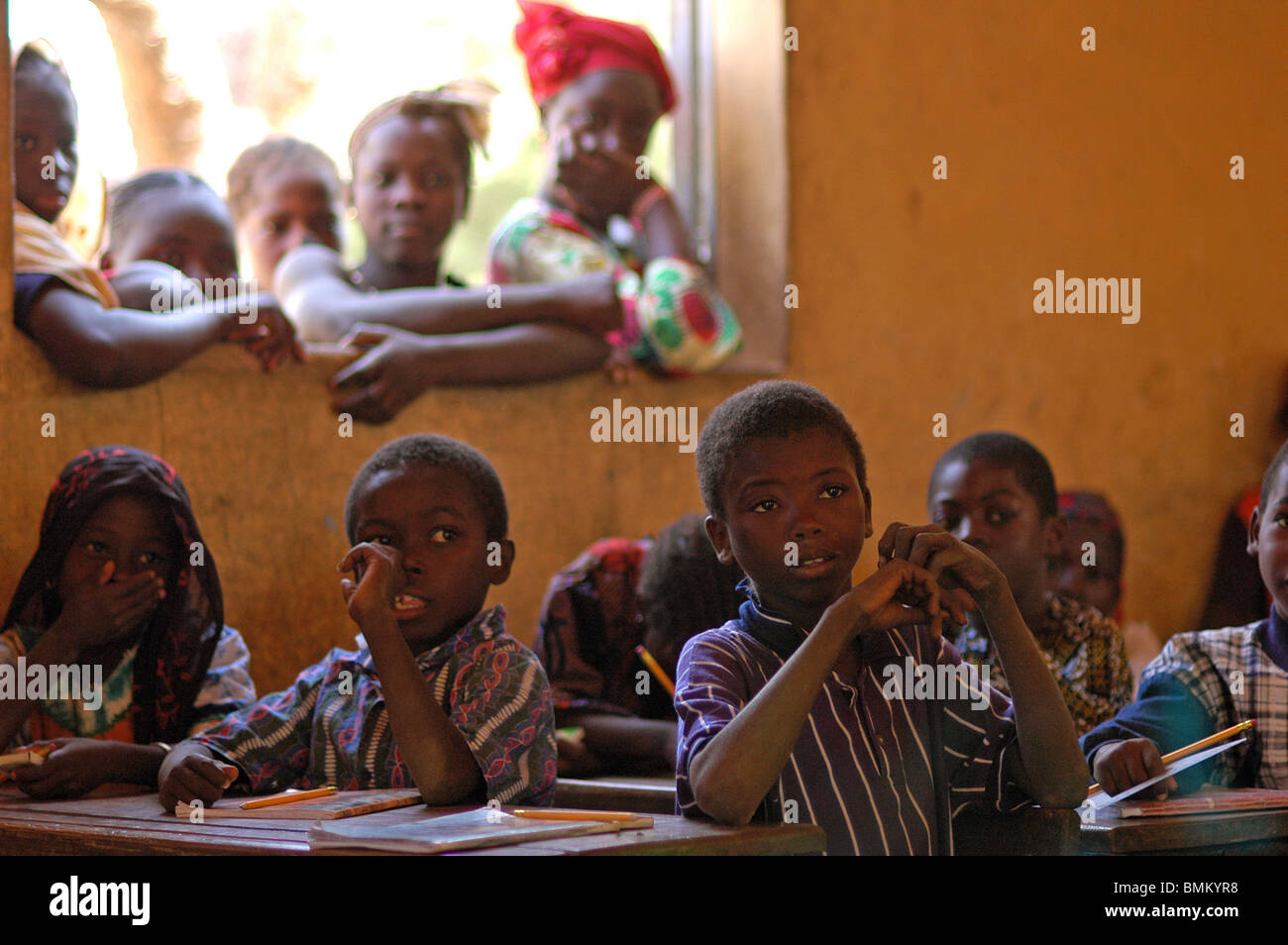 Portrait of children looking inside the classroom from the window Stock ...