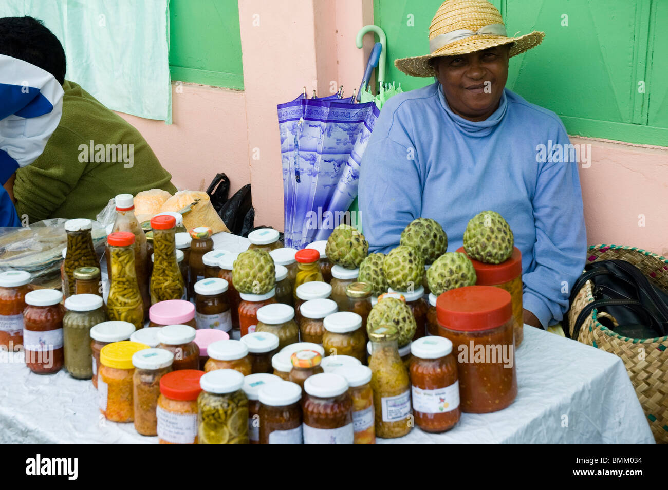 Mauritius, Port Mathurin. Woman selling preserves and bottled pickles ...