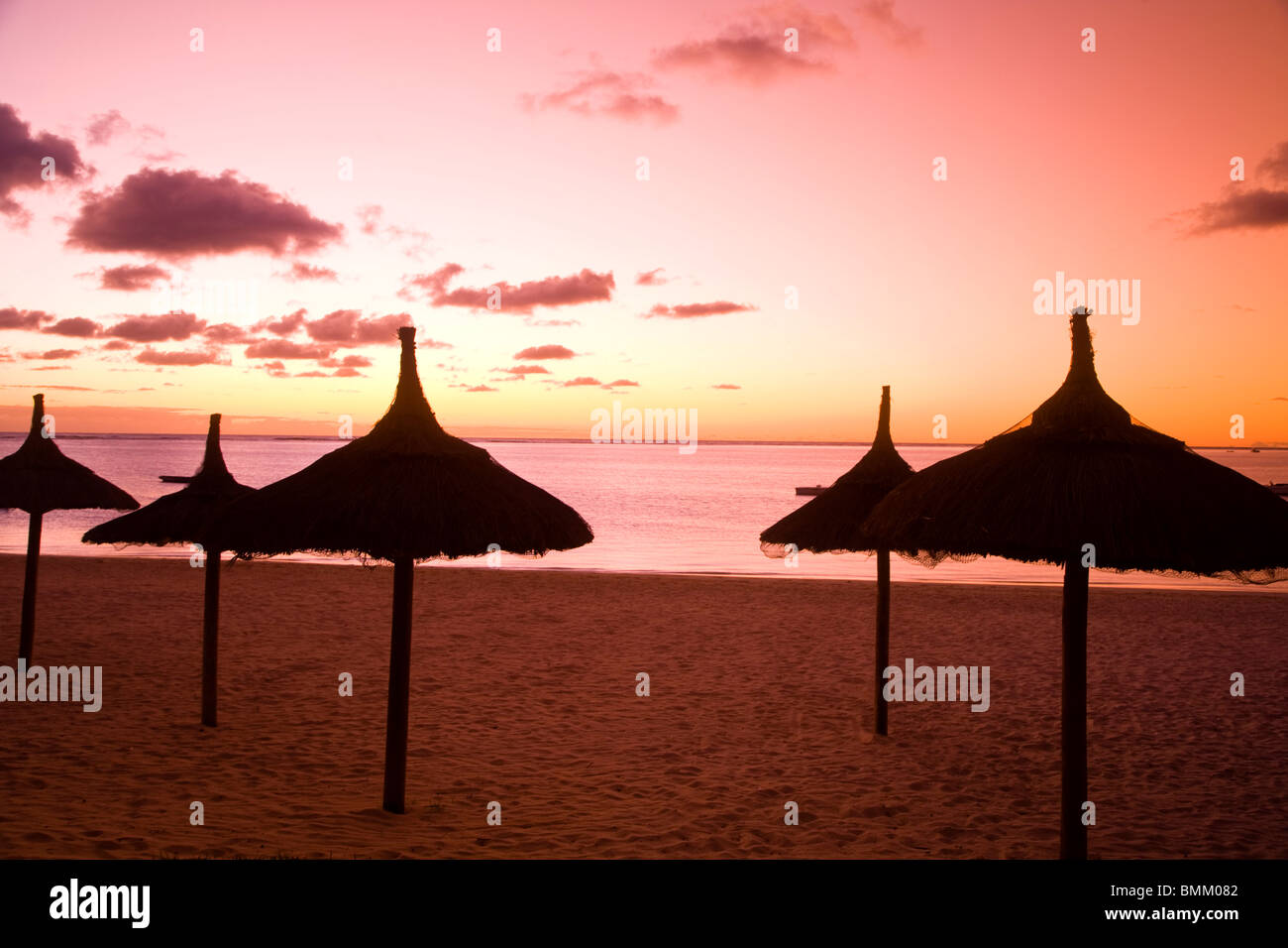 Palapa style beach huts at sunrise, Belle Mare Public Beach, Southeast ...