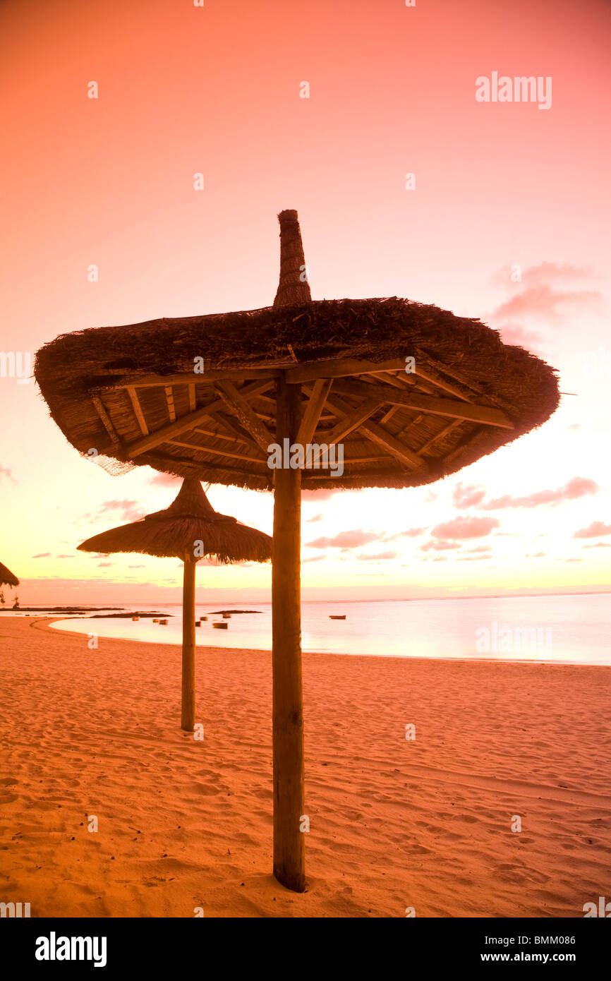 Palapa style beach huts at sunrise, Belle Mare Public Beach, Southeast ...