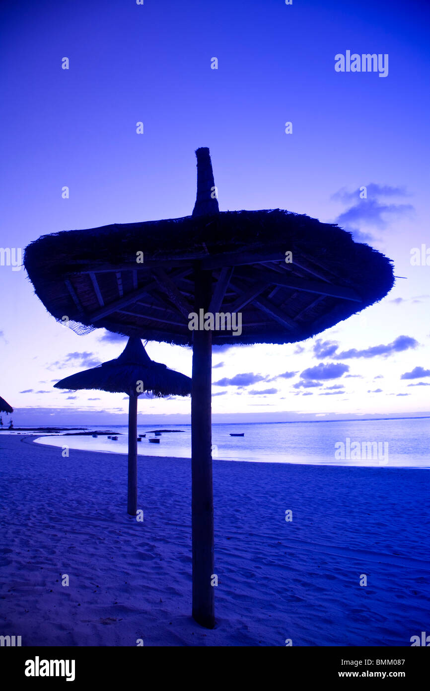 Palapa style beach huts at sunrise, Belle Mare Public Beach, Southeast ...