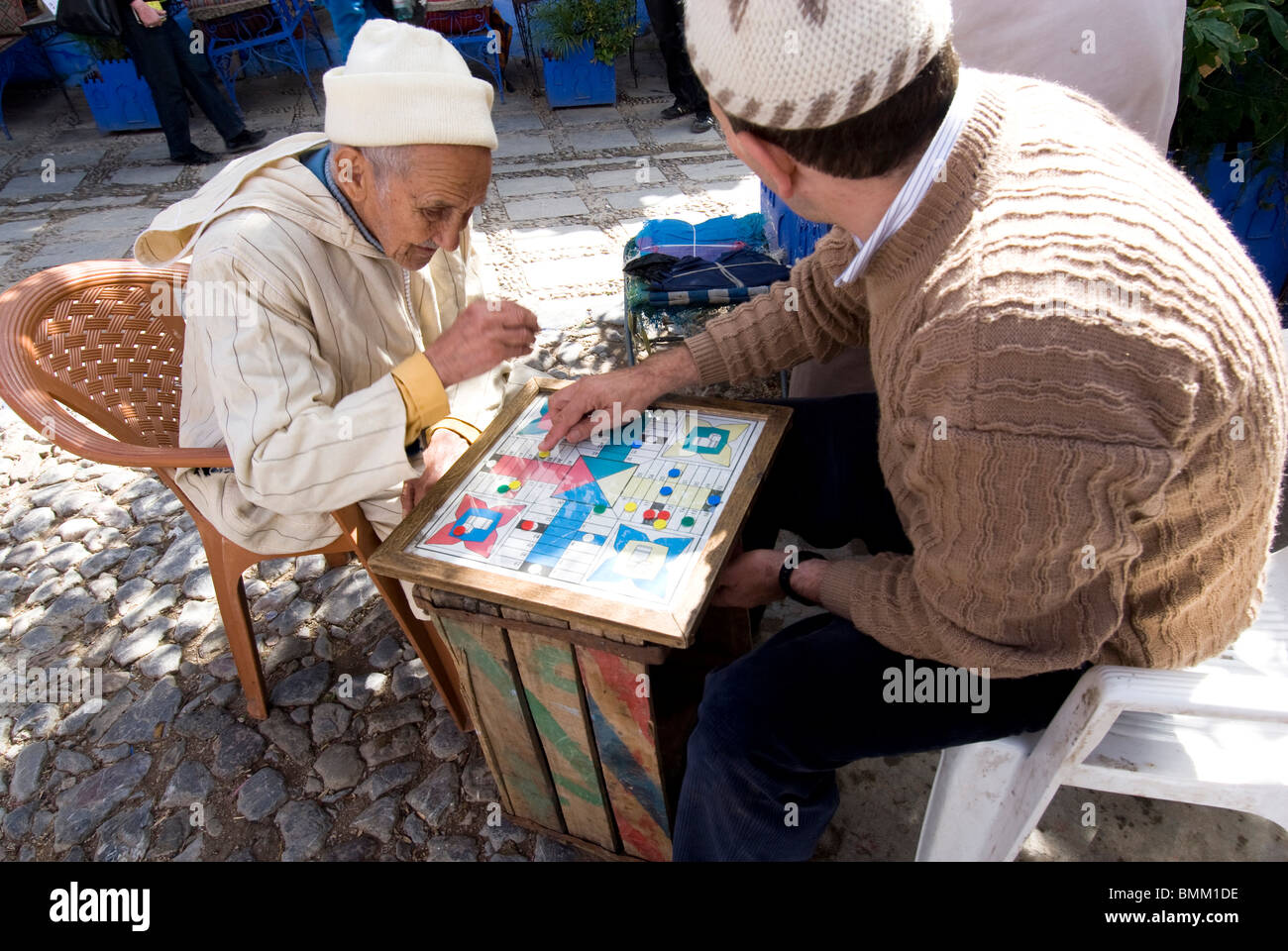 Chefchaouen Morocco two Moroccan men playing a board game in the medina ...
