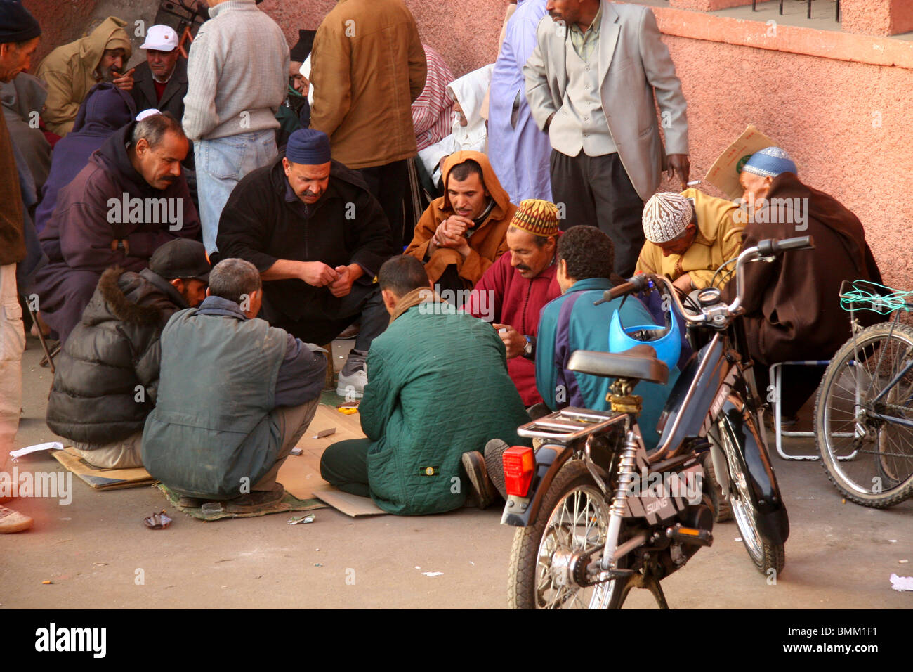 North Africa, Africa, Morocco. A group of Moroccan men gather to play ...