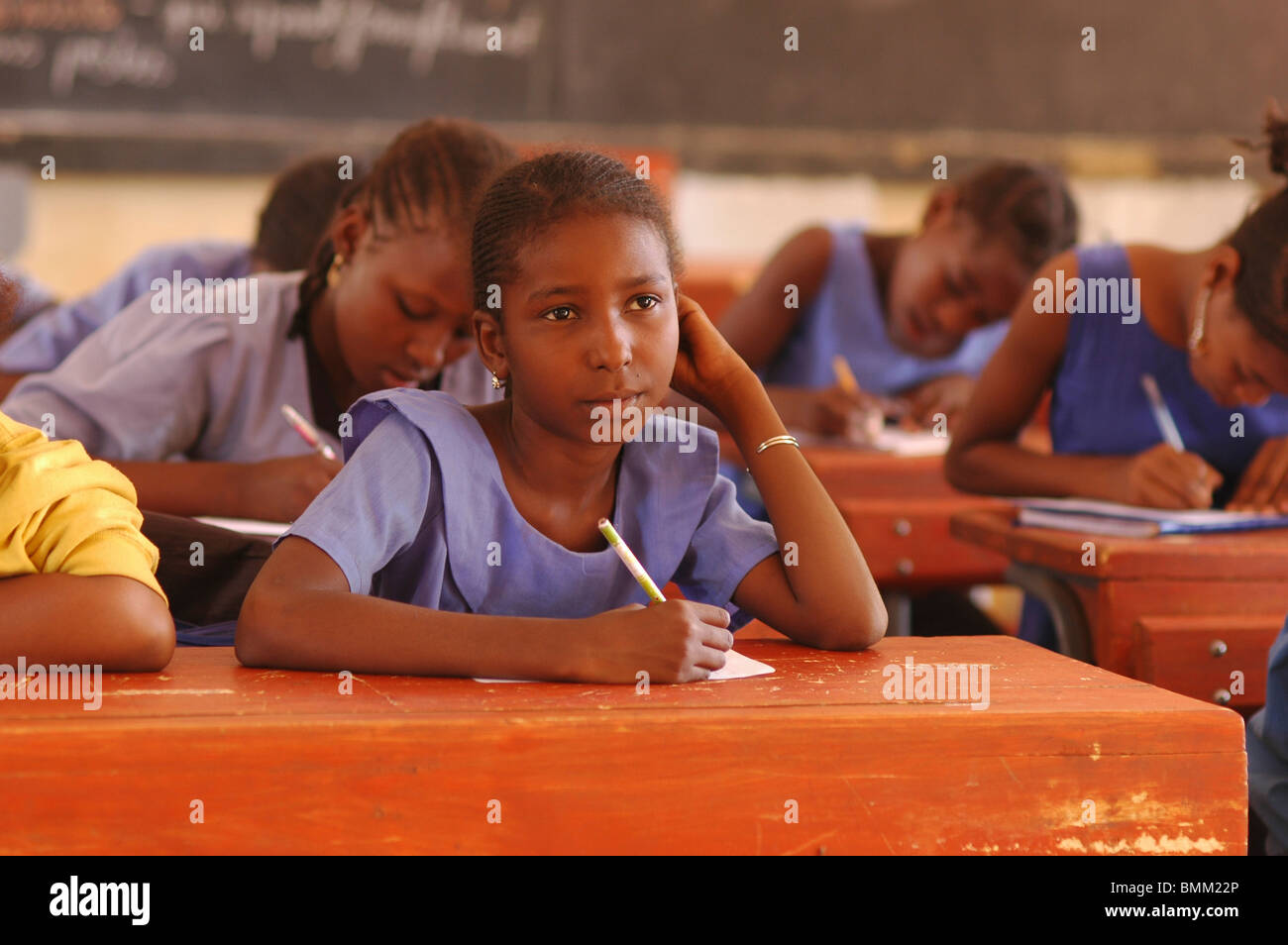 Niger, Niamey, African pupils sitting at their wooden desk in the ...