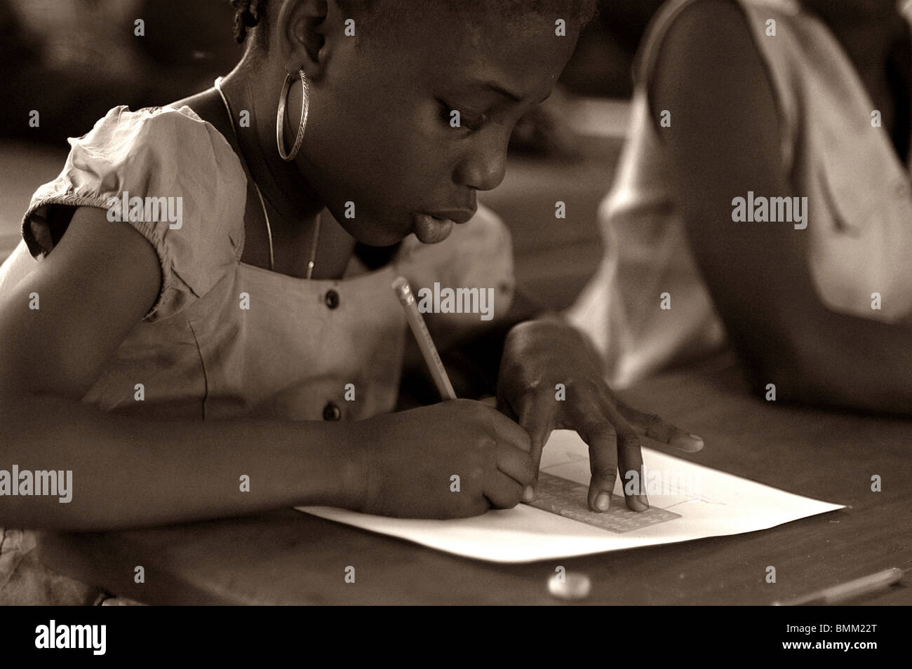 Niger, Niamey, African pupils sitting at their wooden desk in the ...