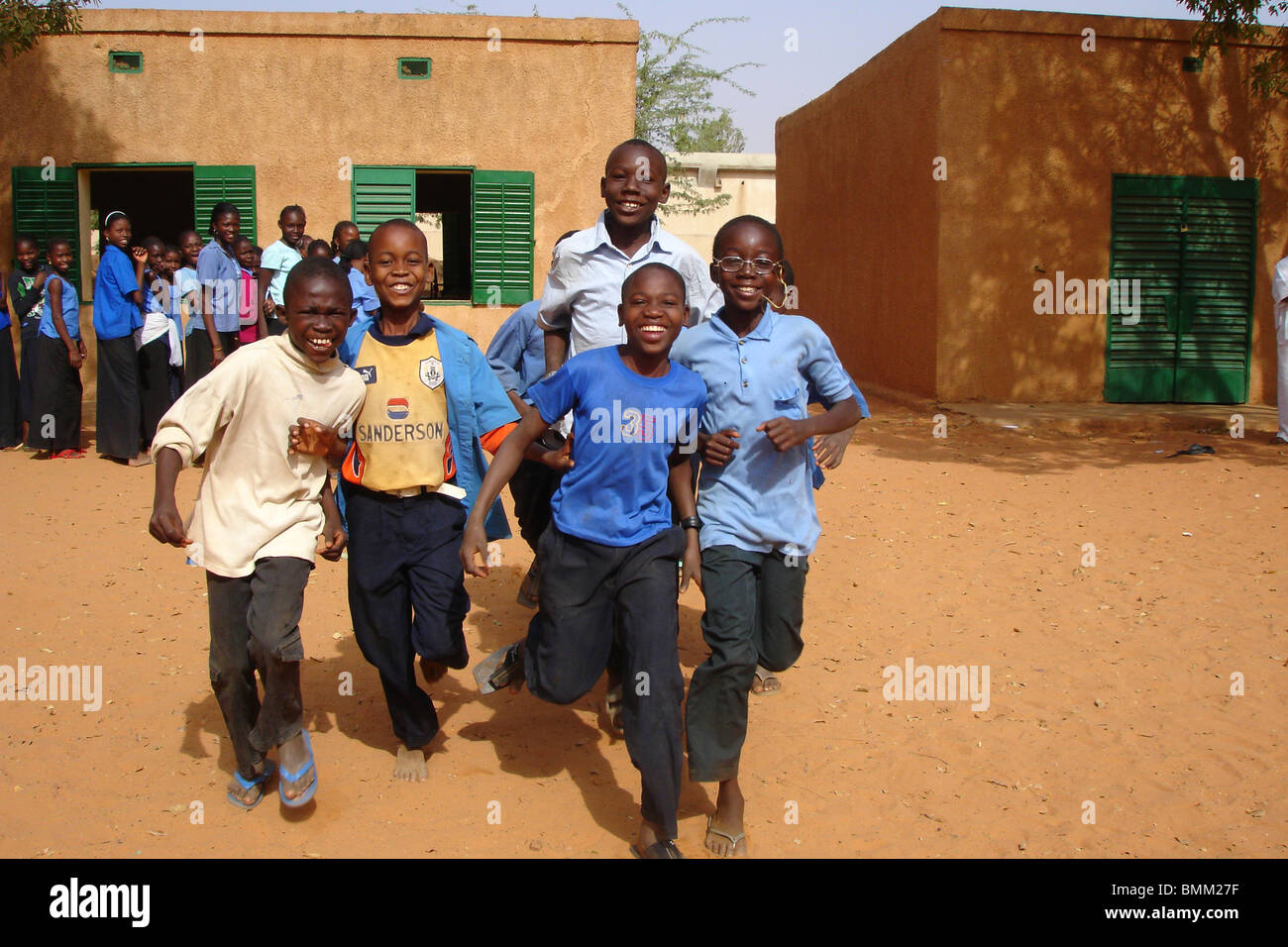 Niger, Niamey, Group of african pupils in their school uniform running ...