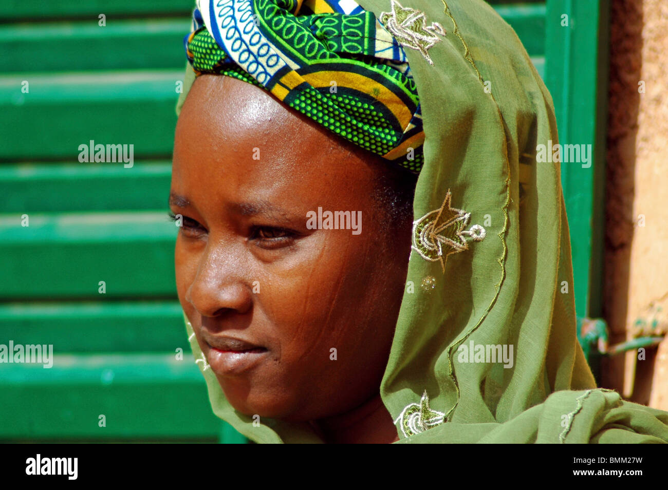 Niger, Niamey, Portrait of an african and muslim woman wearing a green ...