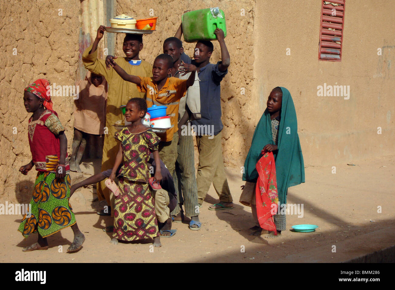 Niger, Niamey, Group of african adolescents carrying iron plates on ...