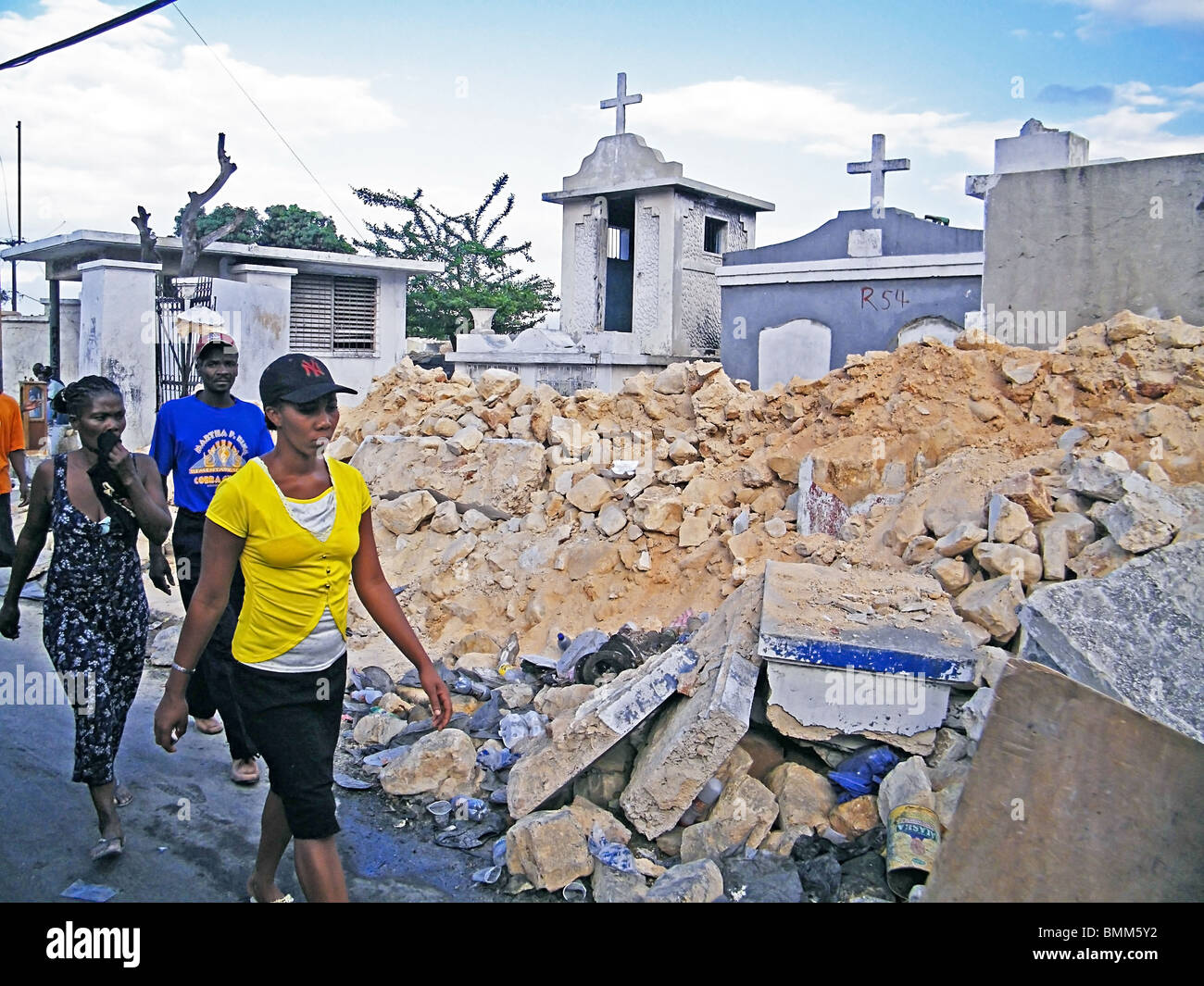 A woman walks past Port au Prince cemetery after the Haiti earthquake ...