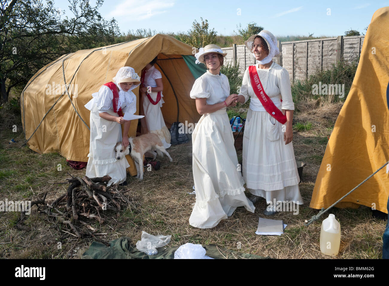 Climate Rush campers and tents on tour at Sipson in white dresses with ...