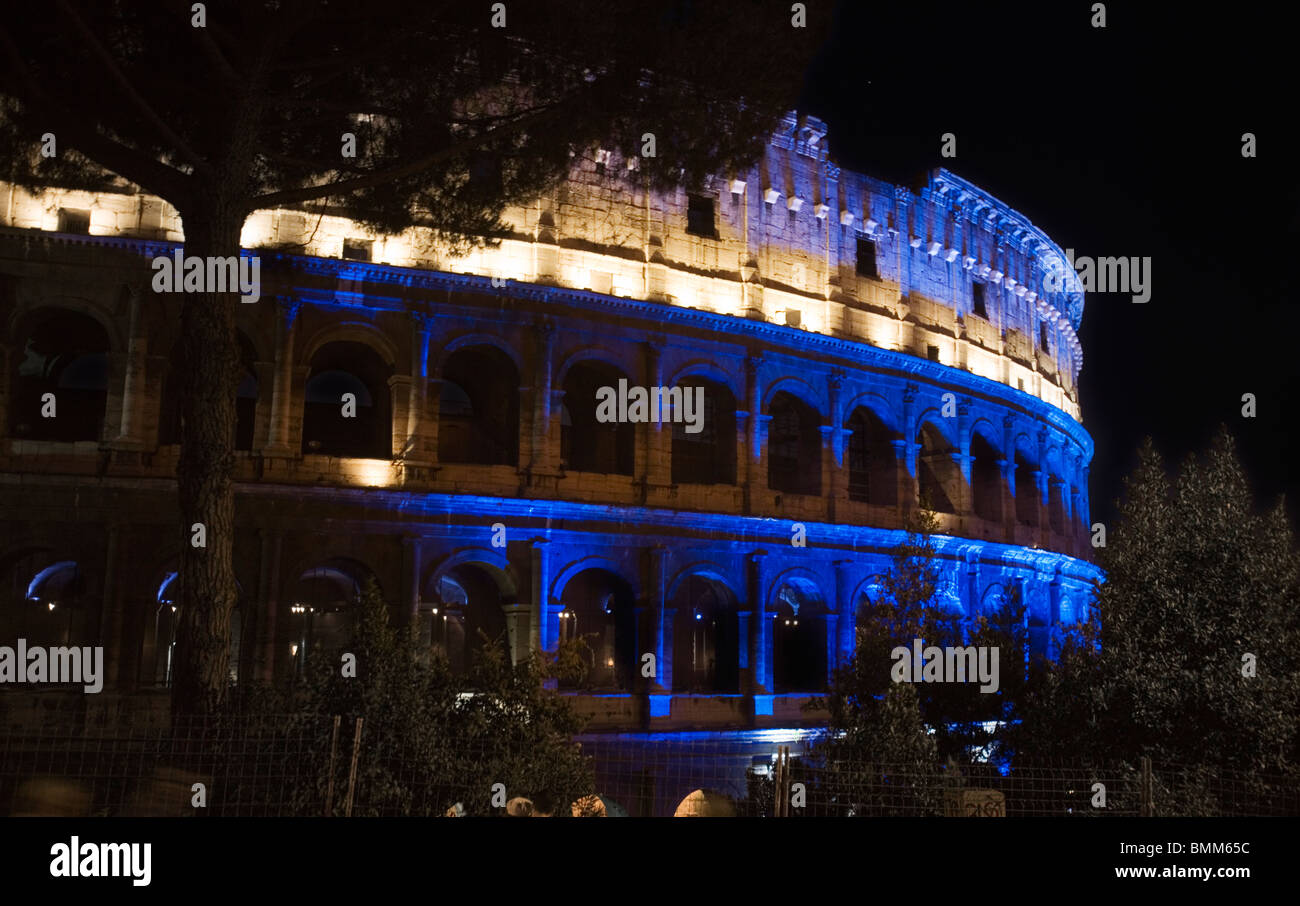The Colosseum at night, lit in colored lights, Rome, Italy Stock Photo ...