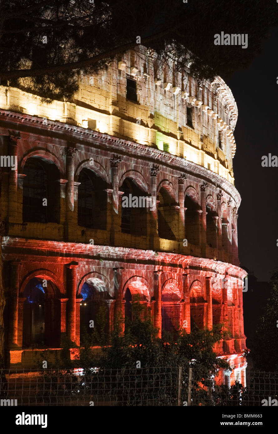 The Colosseum at night, lit in colored lights, Rome, Italy Stock Photo ...