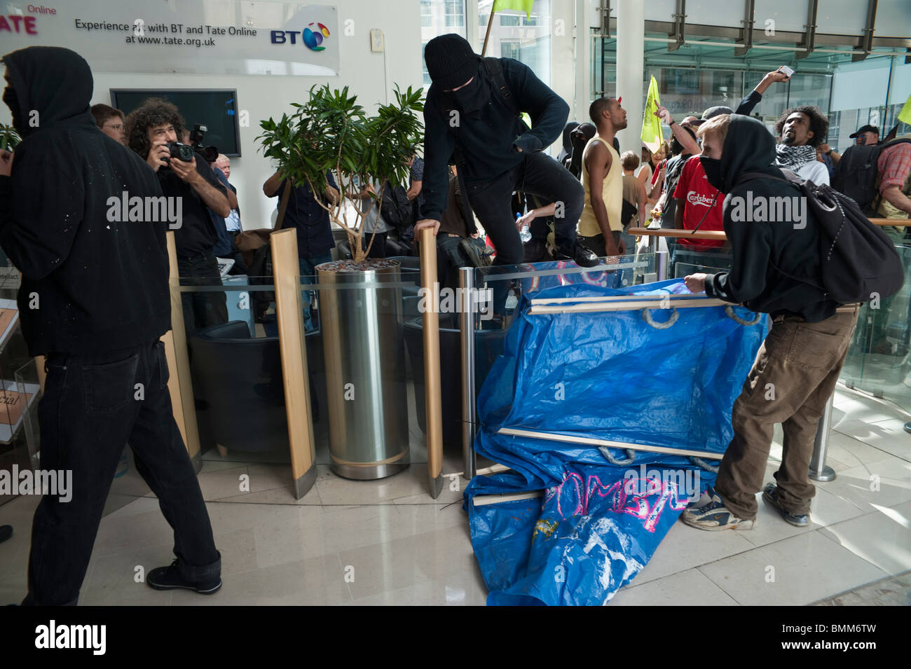 Anarchists climb over barriers in BT offices in Disarm DSEi protest ...