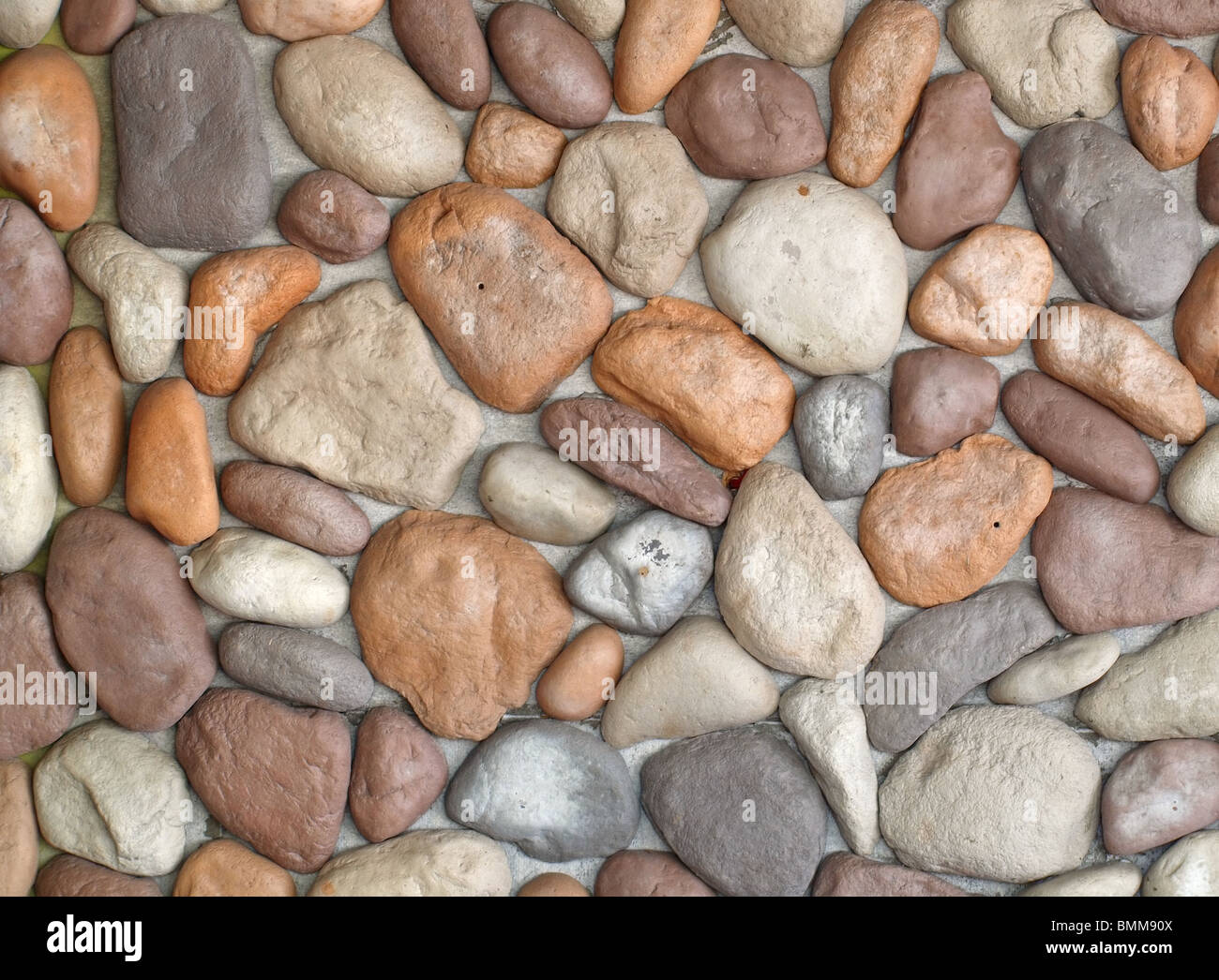A wall decorated with large artificial pebbles in a variety of colors ...