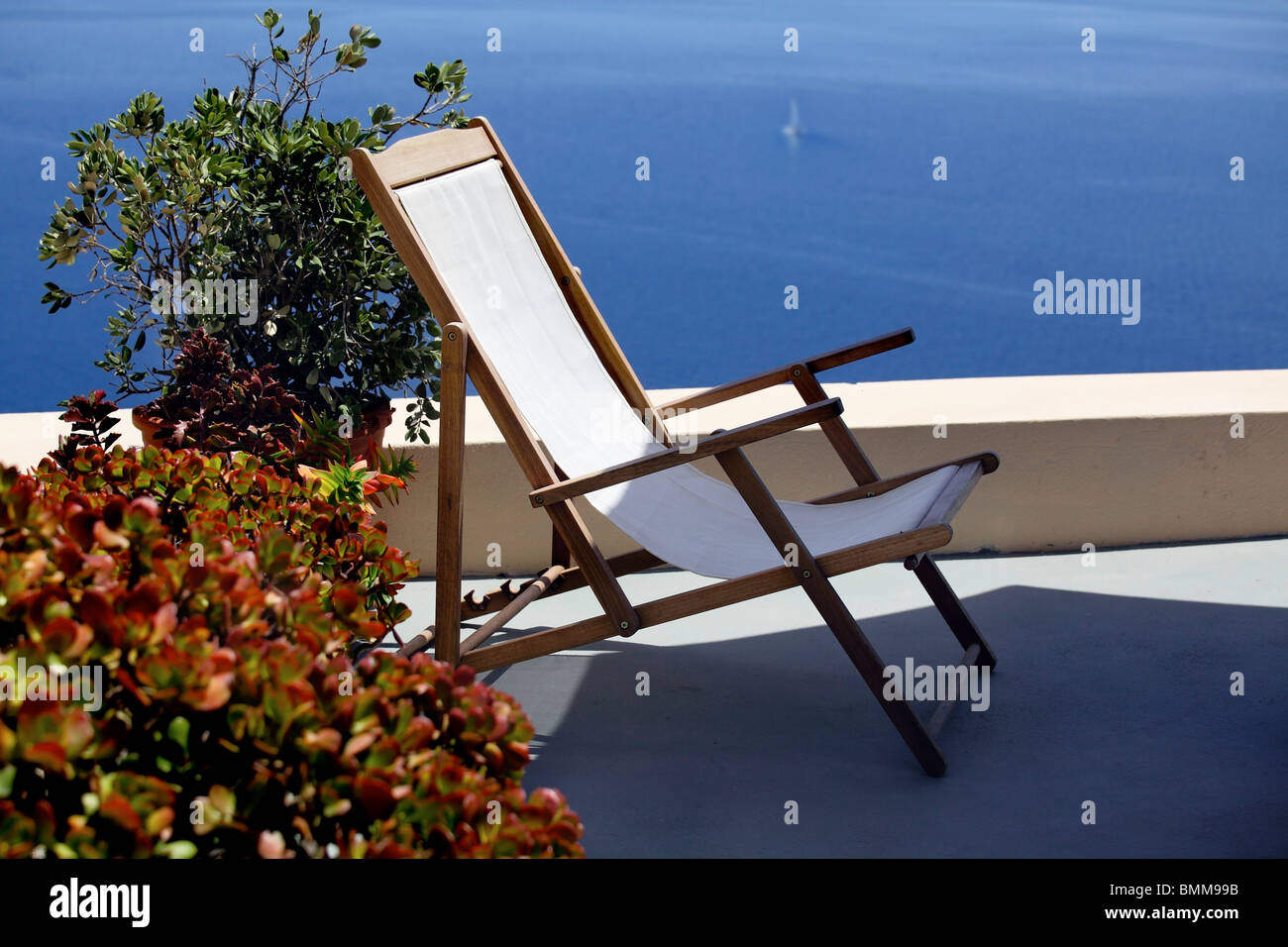 Terace chair with view of Santorini Stock Photo - Alamy