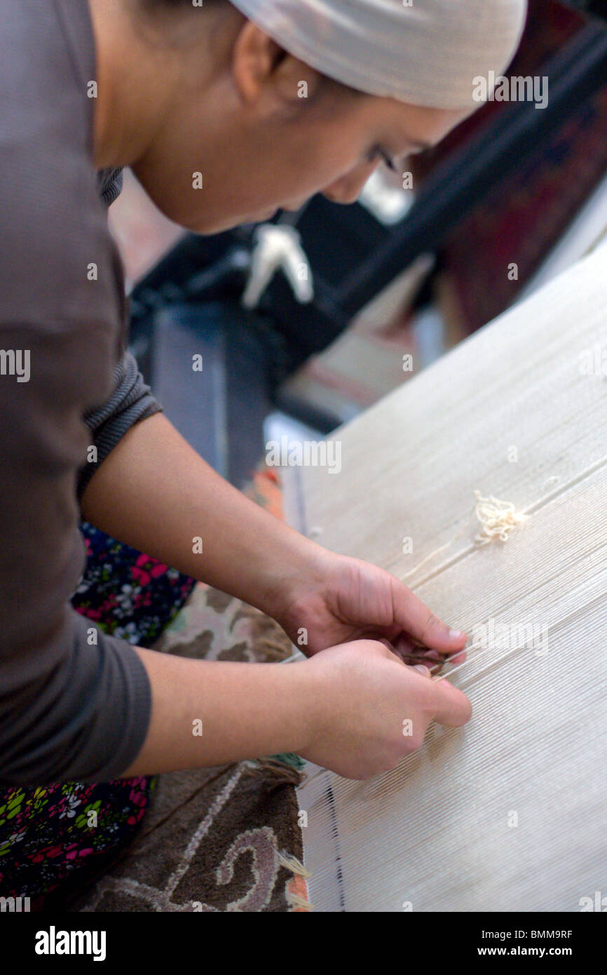 A young woman making a carpet in Turkey Stock Photo - Alamy