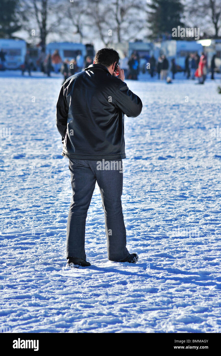 Man on mobile phone in the snow Stock Photo - Alamy