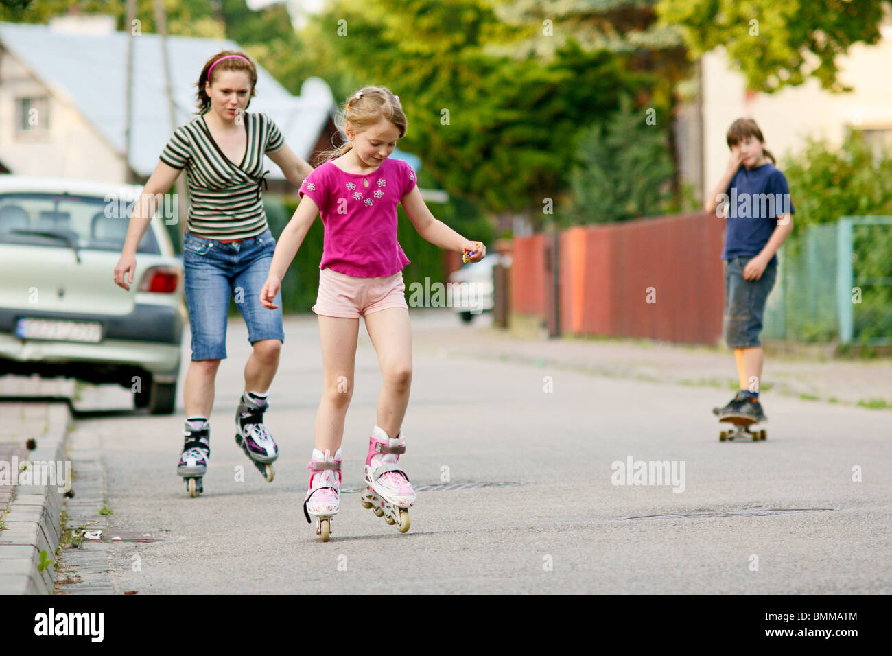 Mum skating with daughter and son Stock Photo - Alamy