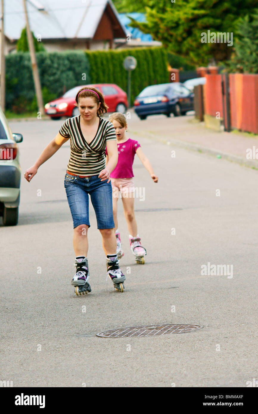 Mum skating with daughter Stock Photo - Alamy
