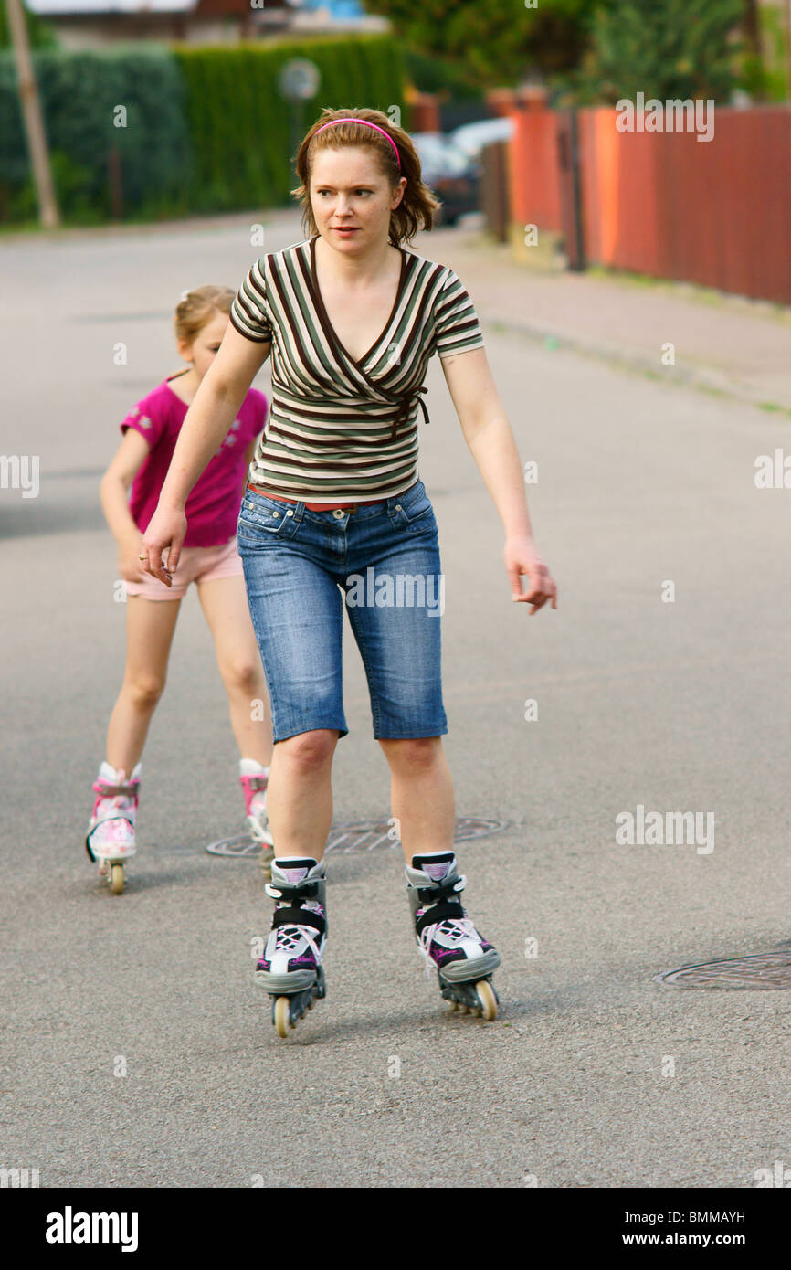 Mum skating with daughter Stock Photo - Alamy