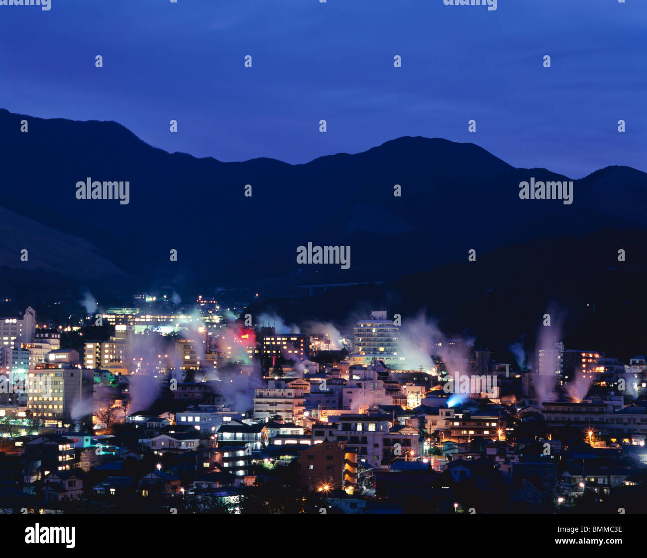 Twilight Beppu City. Steam plumes rise from onsen Stock Photo - Alamy