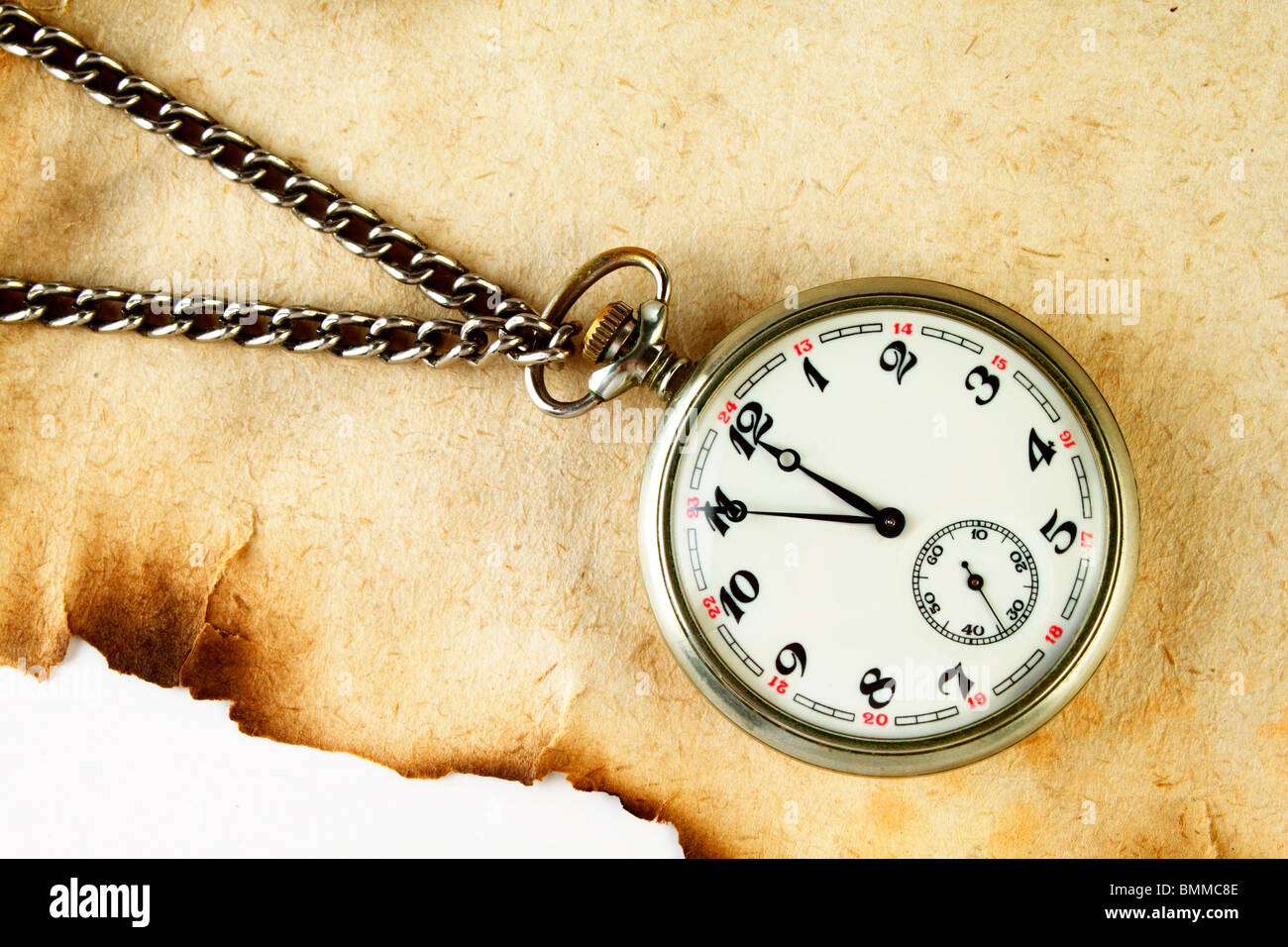 Pocket watch on old paper Stock Photo - Alamy