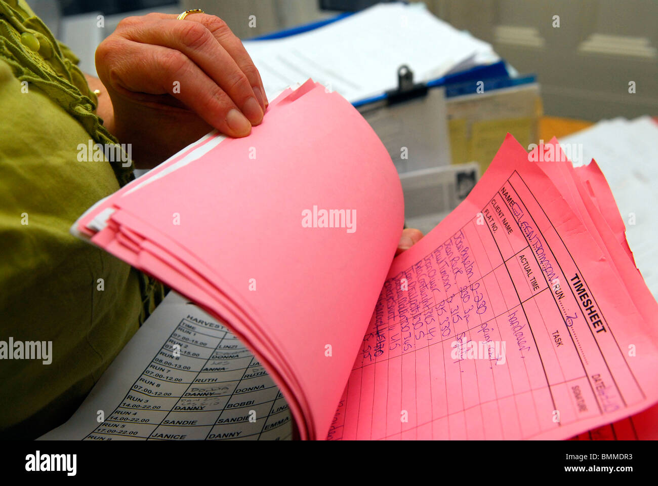 Office staff checking healthcare workers' timesheets, Wirral, UK Stock ...