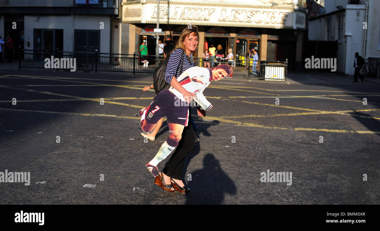 Female England football fan with cardboard cutout of David Beckham in ...
