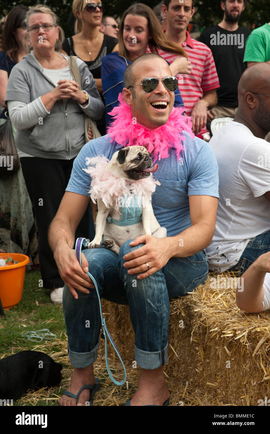 Man with pink ruff and dog with white ruff at dog show, Bermondsey ...