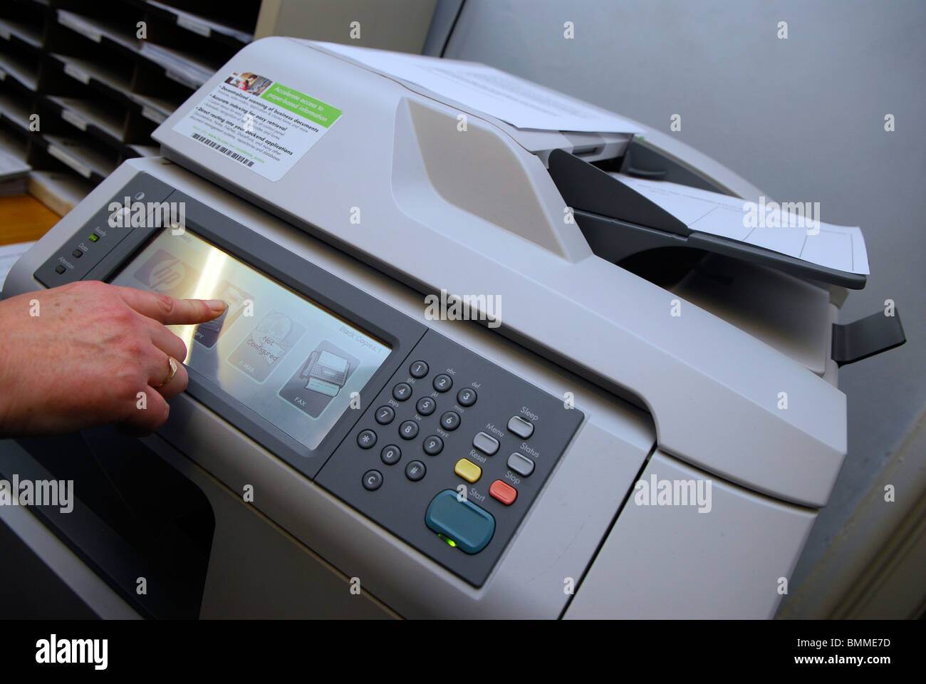 Office worker using copying machine, Wirral, UK Stock Photo - Alamy