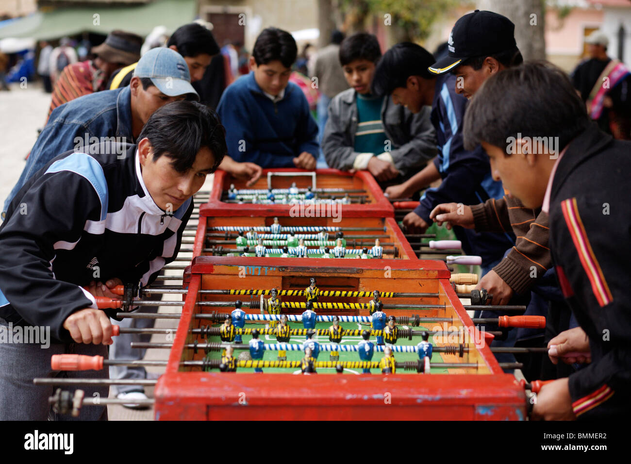 Men play table football or fusball or foosball in a square in the ...